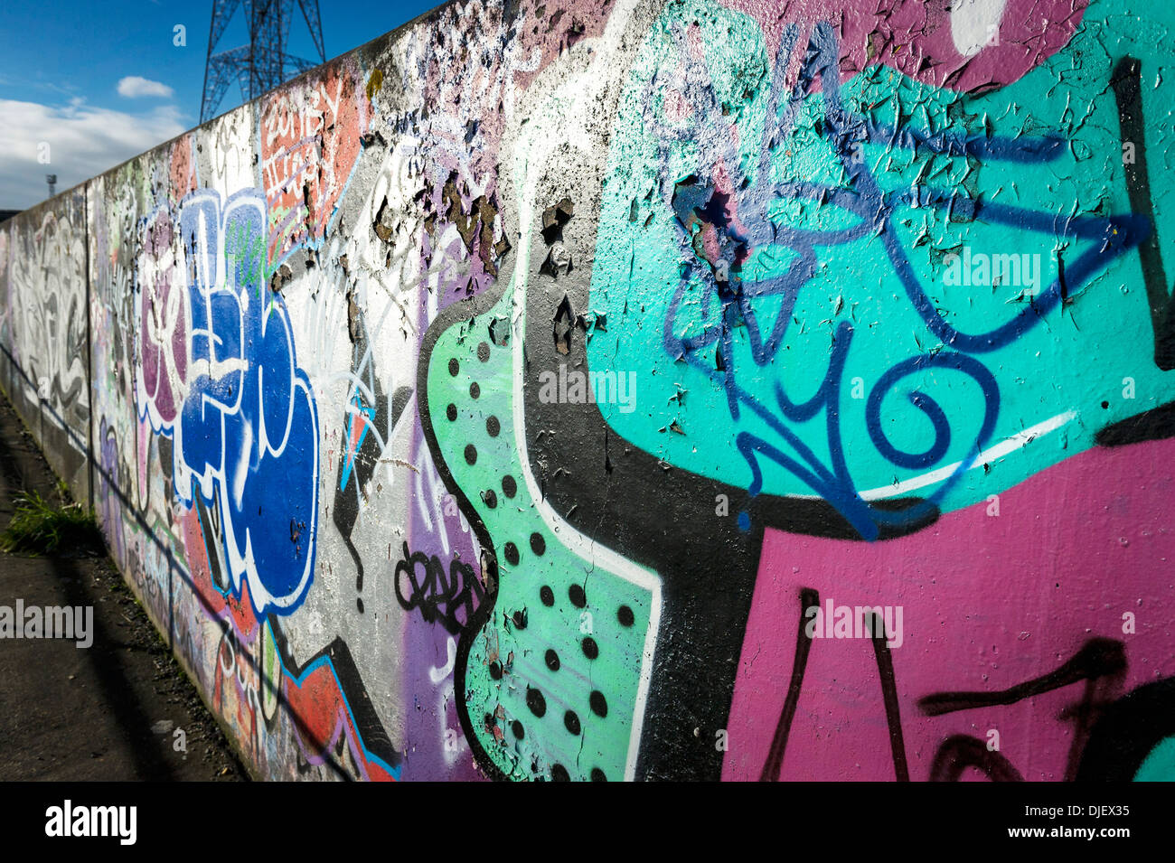 A concrete wall covered in Graffiti Stock Photo - Alamy