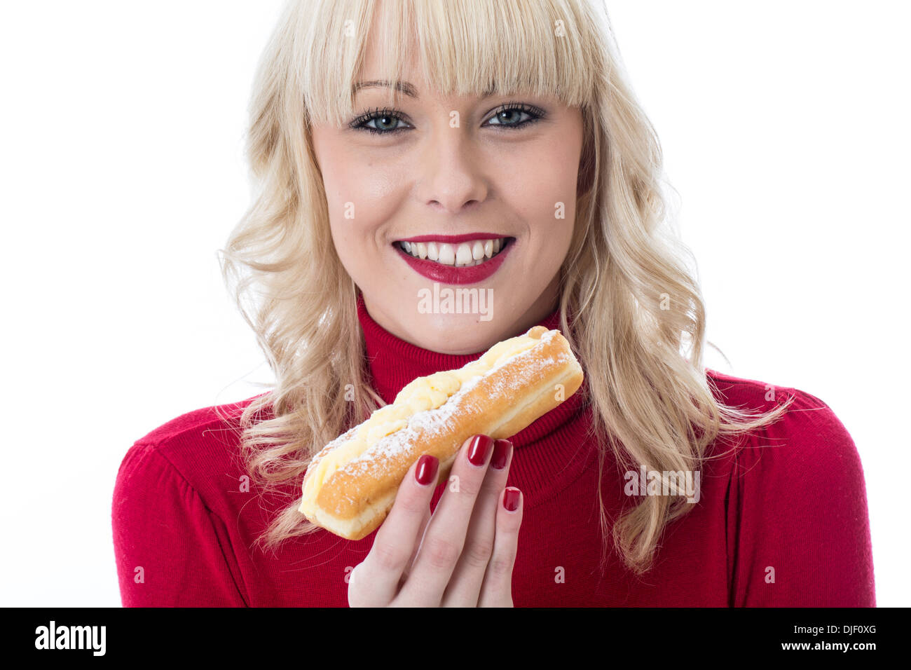 Model Released. Happy Young Woman Eating a Cream Cake Stock Photo - Alamy