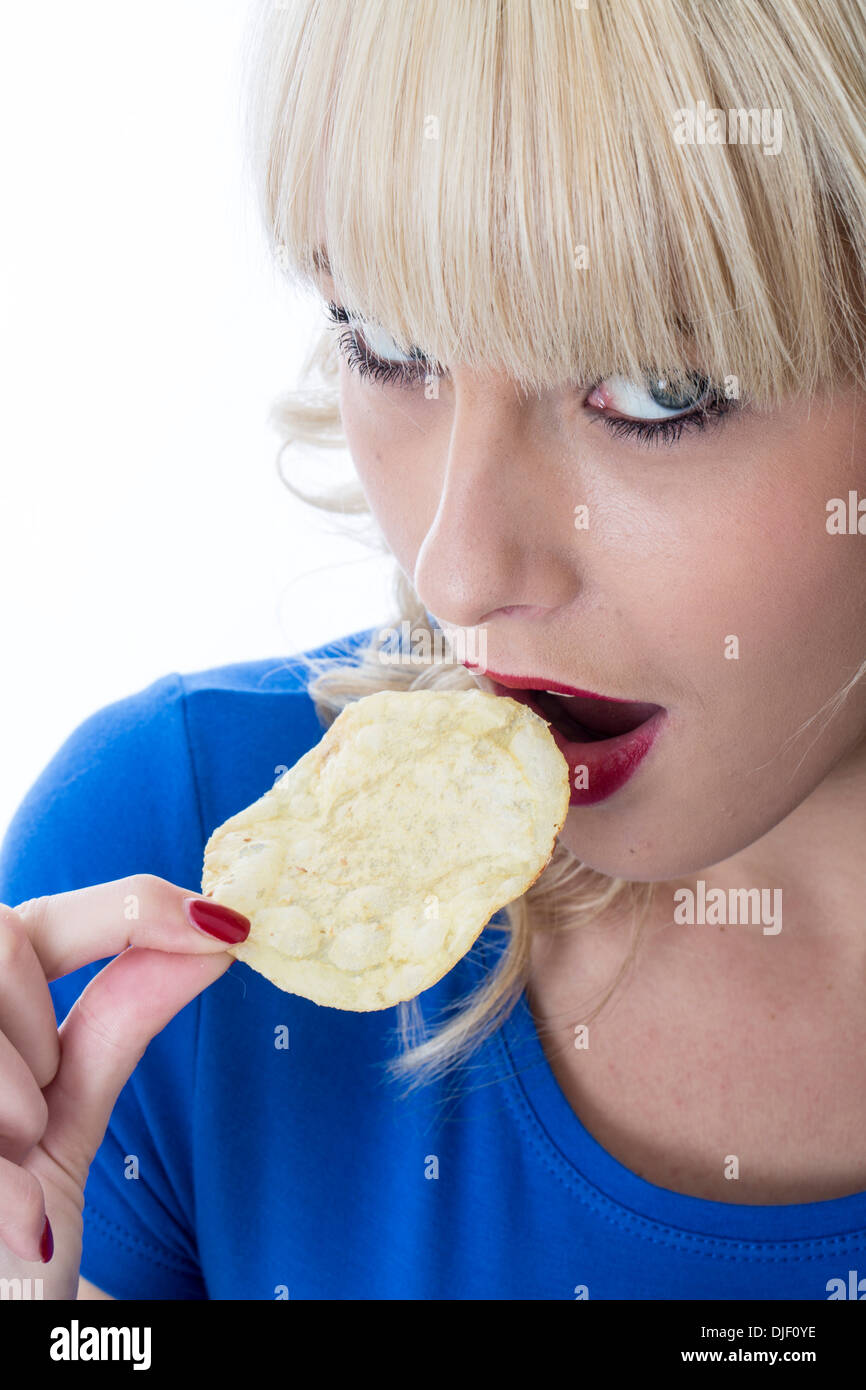 Model Released. Young Woman Eating Potato Crisps Stock Photo - Alamy