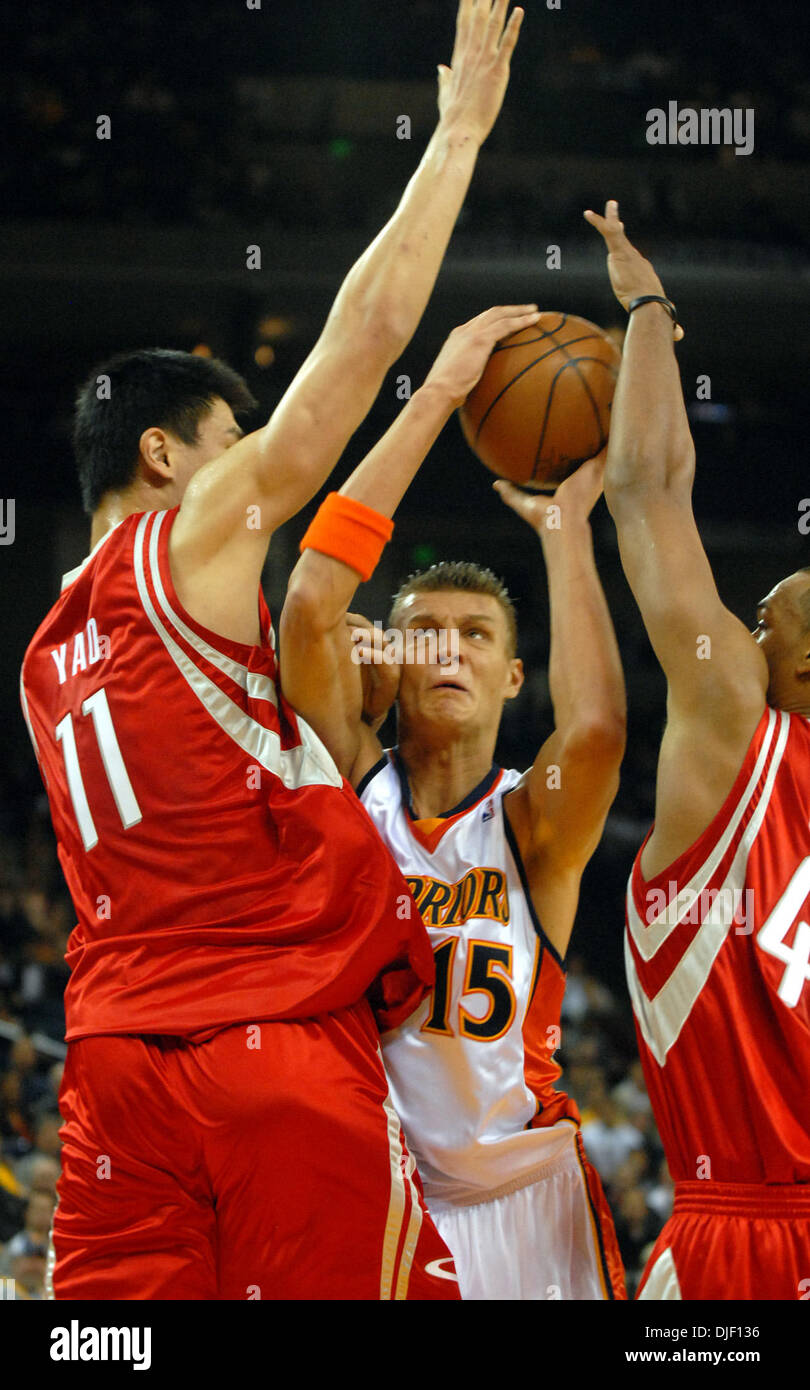 Warriors center Andris Biedrins gets caught between Rockets Yao Ming ...