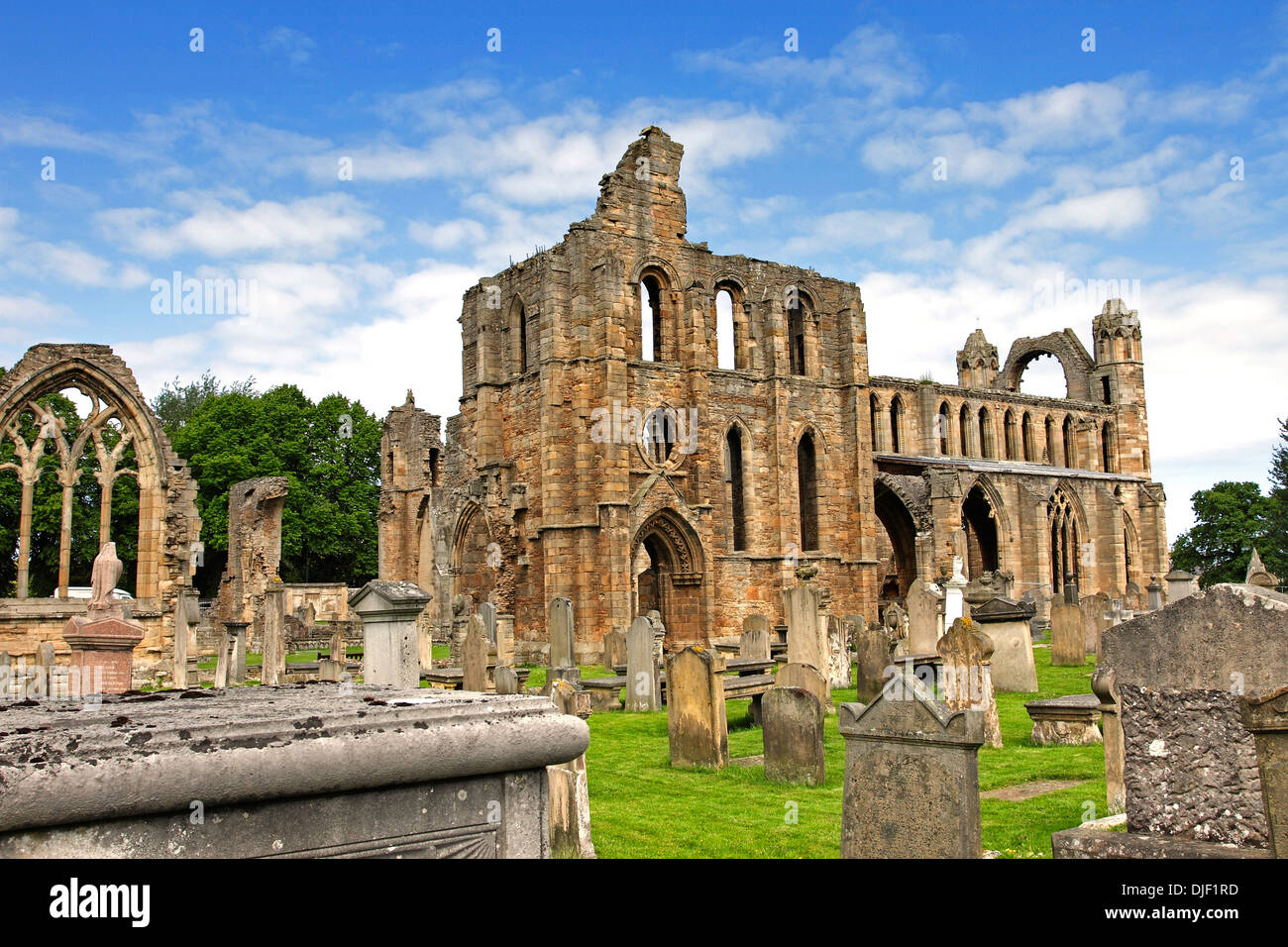 The ruined facade and ancient gravestones of the derelict medieval ...