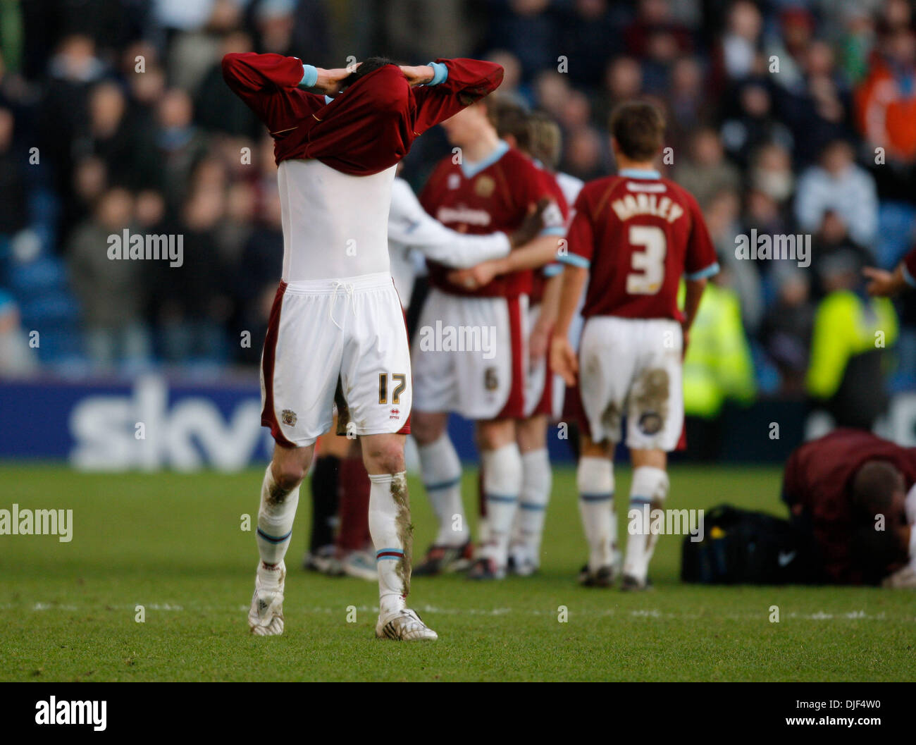 Kyle Lafferty of Burnley hides his head after being sent off for a ...