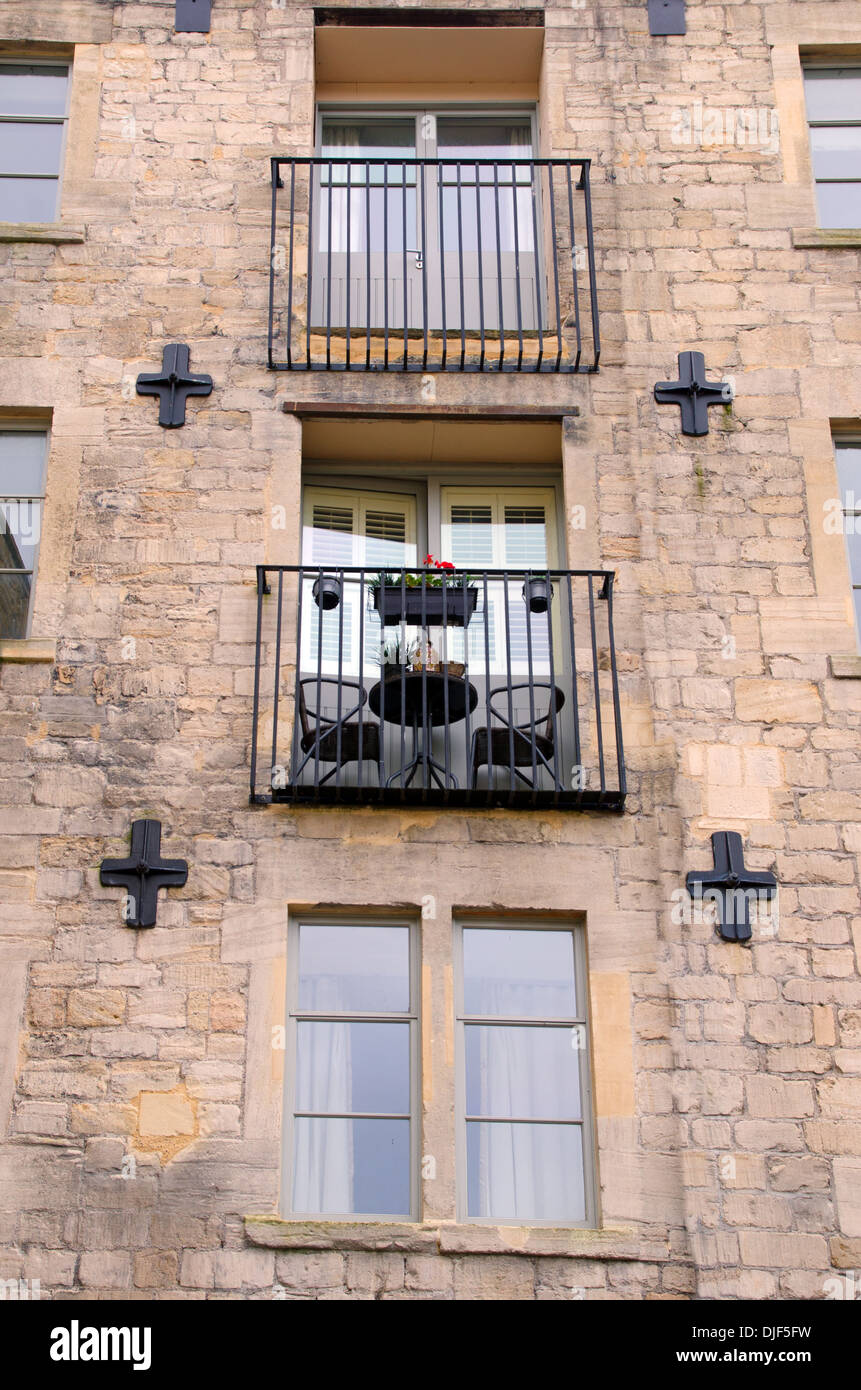 Building facade showing table and chairs on a rustic balcony Stock ...