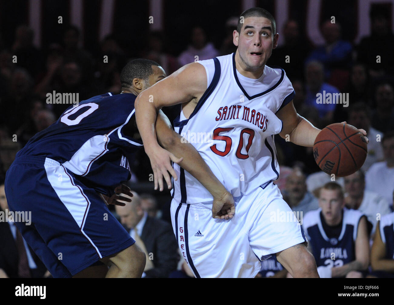 St. Mary's Gaels Omar Samhan, #50, drives past Loyola Marymount Lions ...