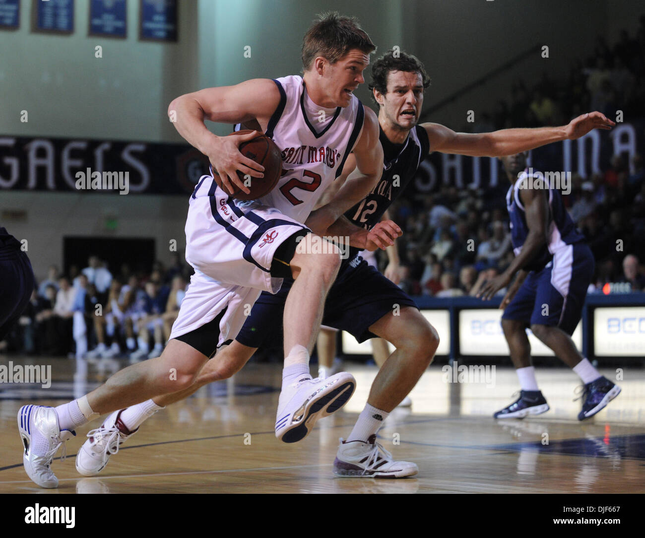 St. Mary's Gaels Lucas Walker, #12, drives past Loyola Marymount Lions ...