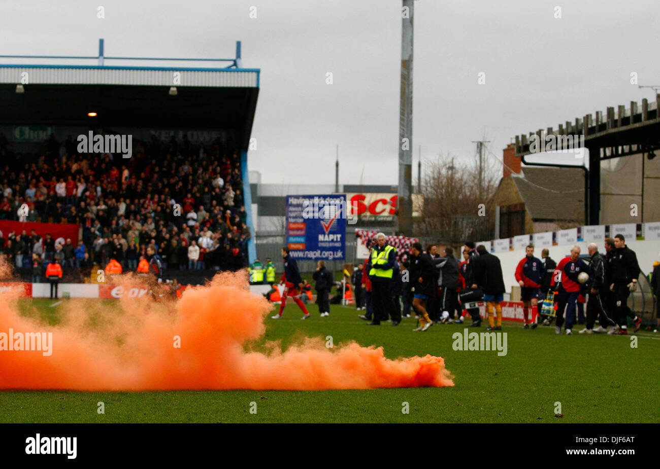 A smoke flare thrown from outside the ground lands on the Mansfield ...