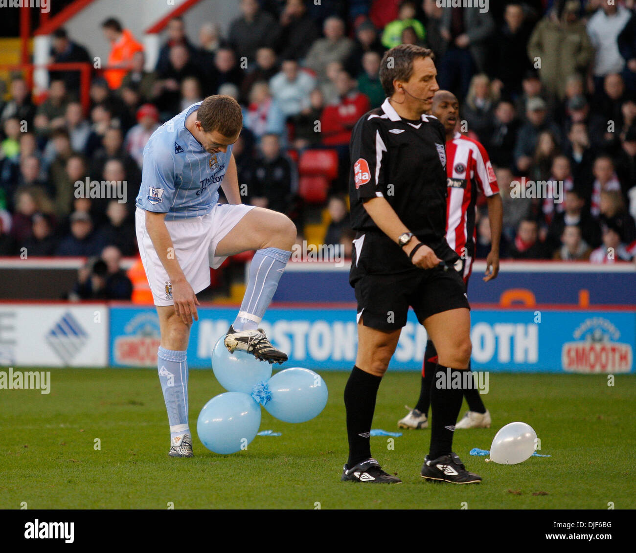 Richard Dunn of Manchester City bursts balloons just before the first ...