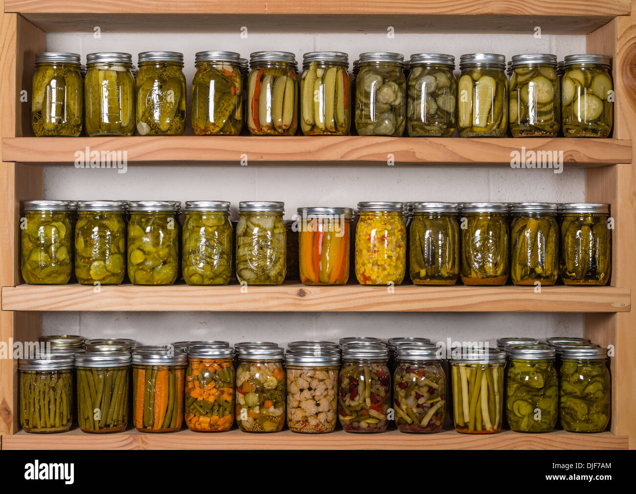 Storage shelves in pantry with homemade canned preserved fruits and ...