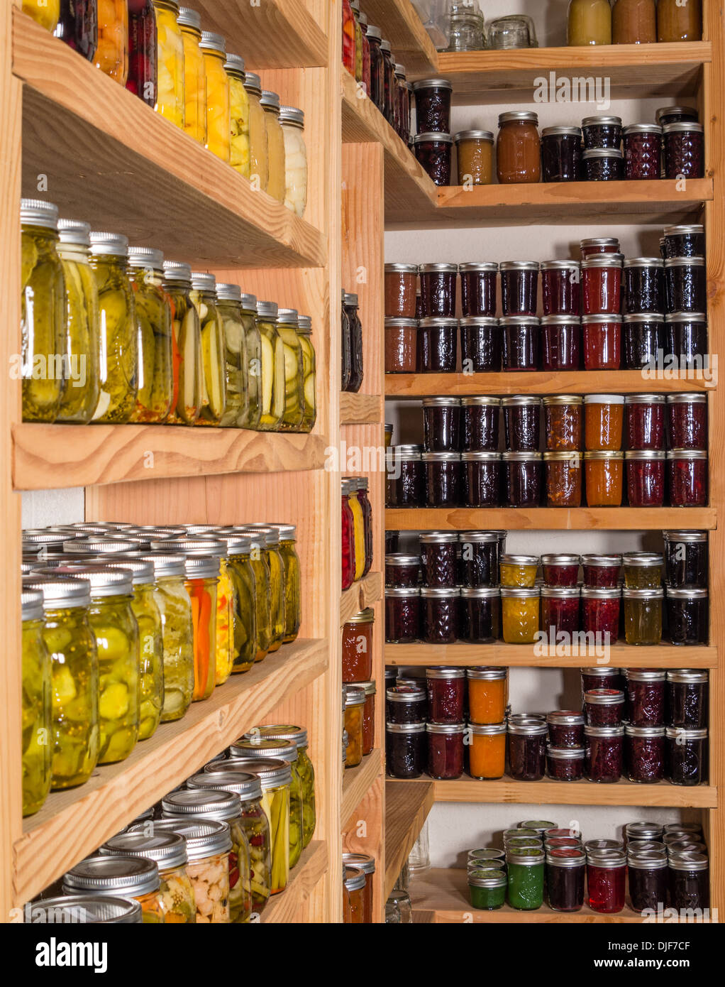 Storage shelves in pantry with homemade canned preserved fruits and ...