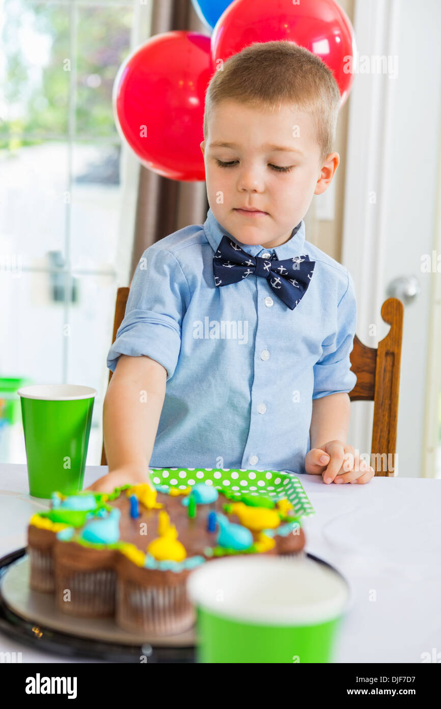 Boy Eating Birthday Cake Stock Photo - Alamy