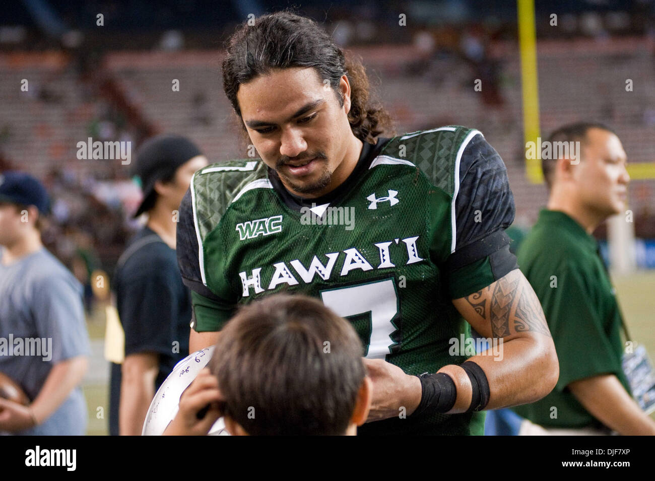 Hawaii quarterback Bryant Moniz #17 gives a fan an autograph after the ...