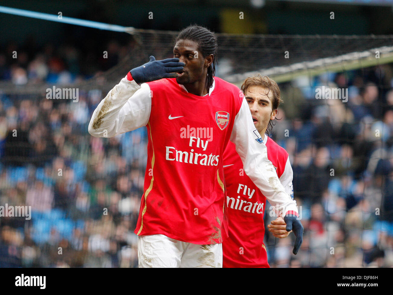 Emmanuel Adebayor of Arsenal celebrates the third goal and blows the ...