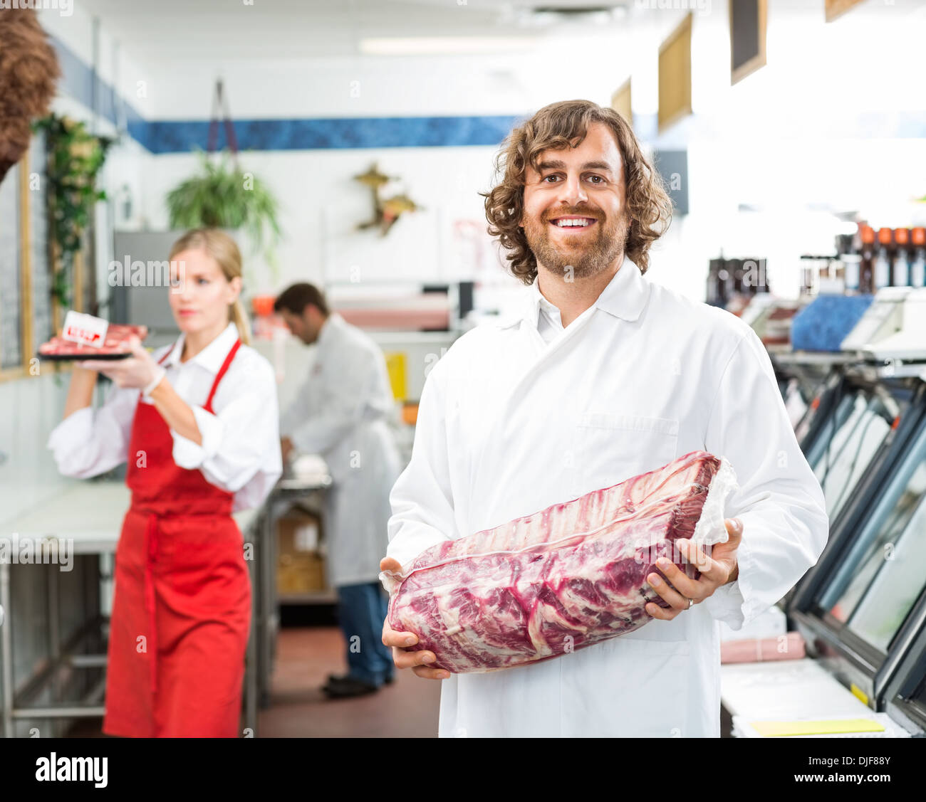 Portrait Of Happy Butcher Holding Meat Package Stock Photo - Alamy