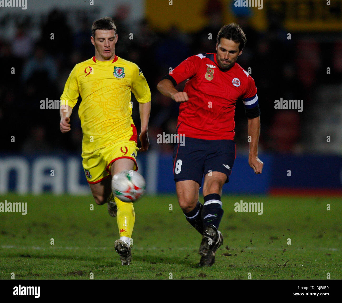 Martin Andersen of Norway clears under pressure from Jason Koumas of ...