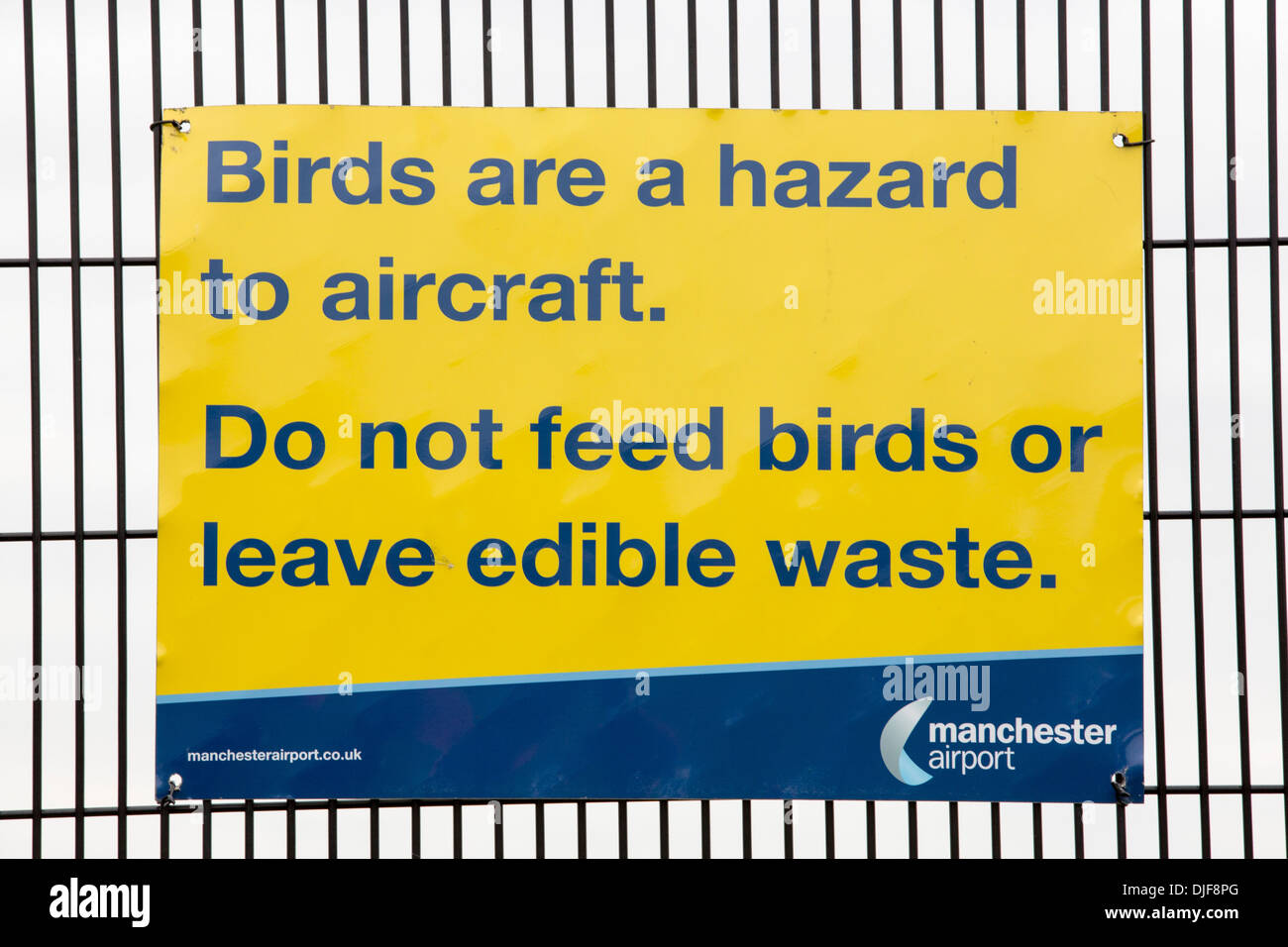 Signs about bird strikes on security fencing at Manchester Airport, UK ...