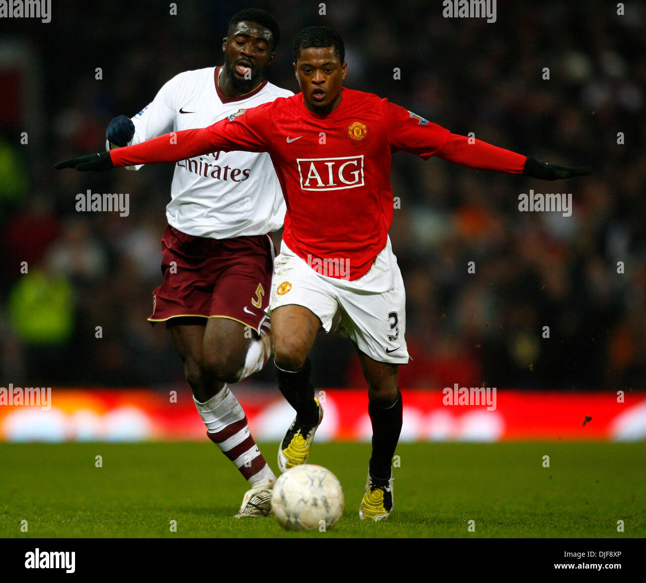 Manchester United's Patrice Evra chased by Kolo Toure of Arsenal ...
