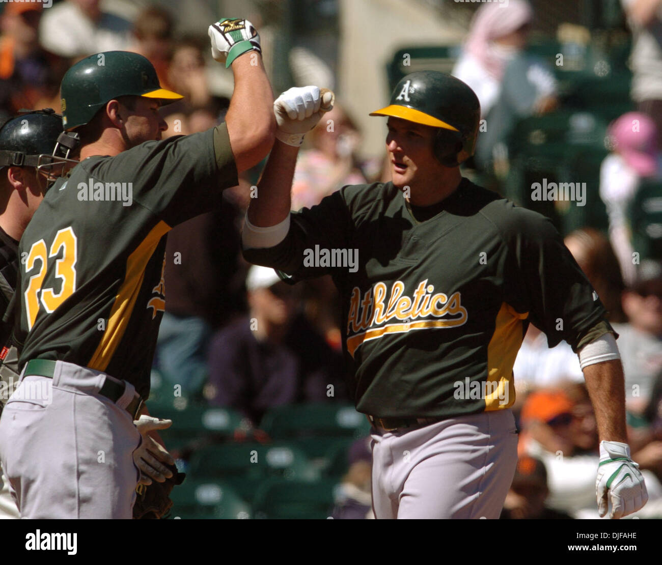 Oakland Athletics Mike Sweeney gets a forearm bash from Todd Linden ...