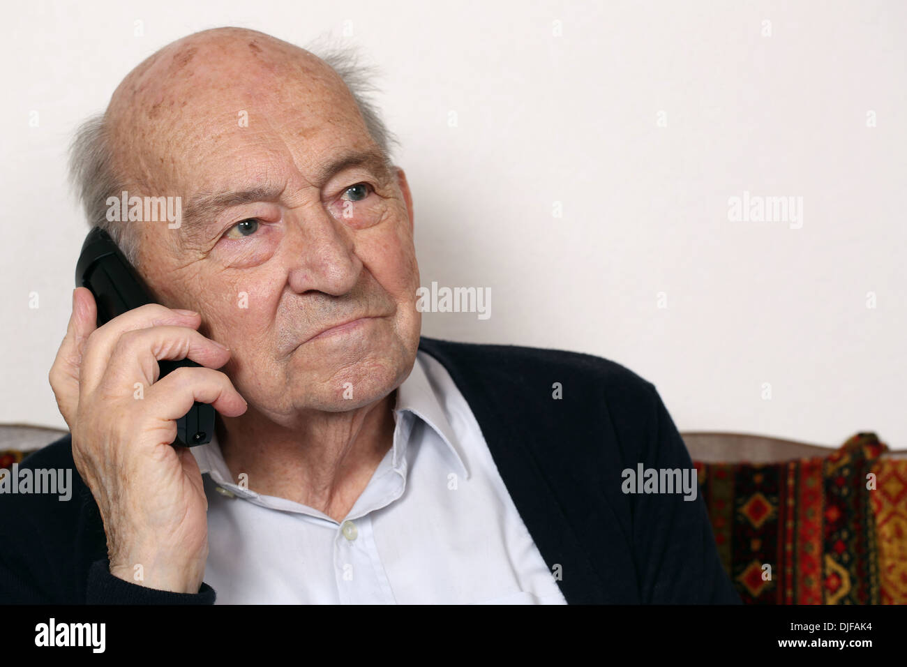 Portrait of an old senior man with a telephone Stock Photo - Alamy