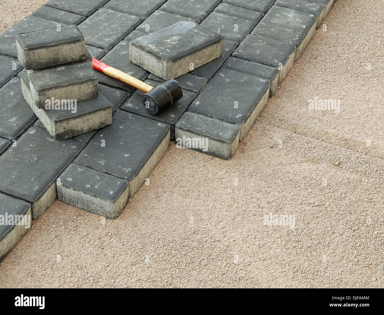 Unfinished driveway being laid from gray concrete pavement blocks Stock ...