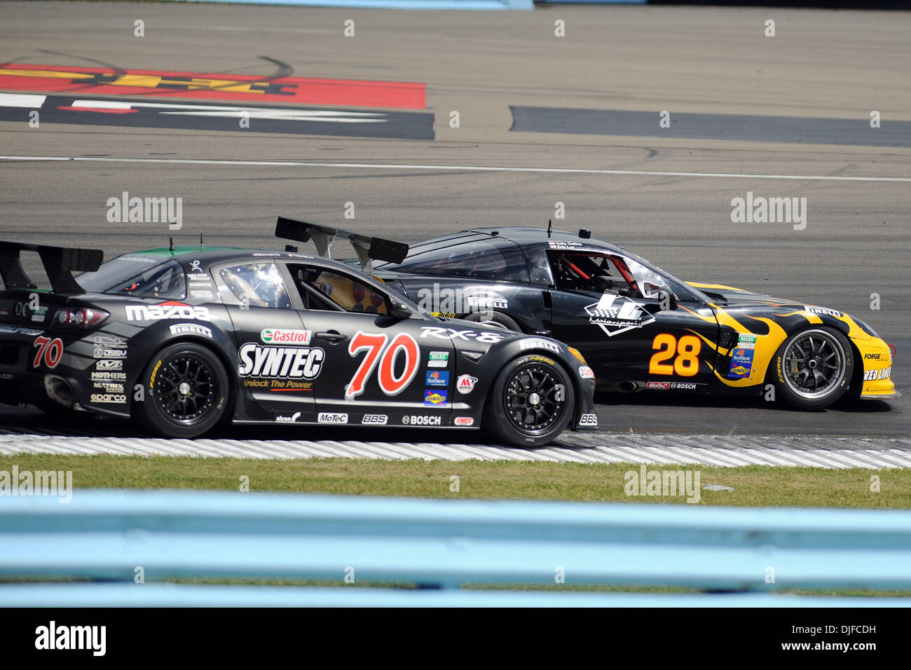 The Mazda RX-8 of Sylvian Tremblay and Jonathan Bomarito (70) passes ...