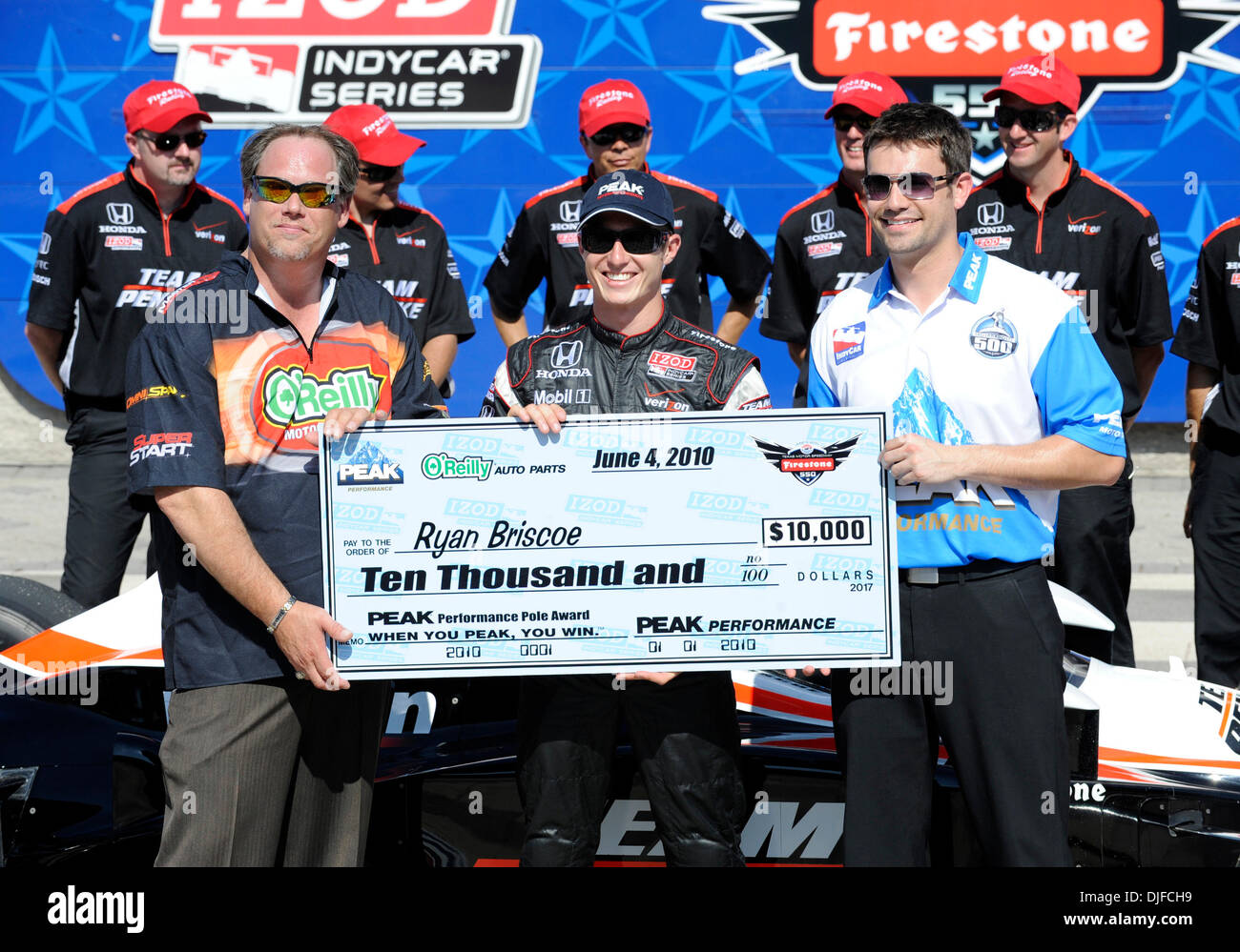 Ryan Briscoe of Team Penske is awarded a check after he secured his ...
