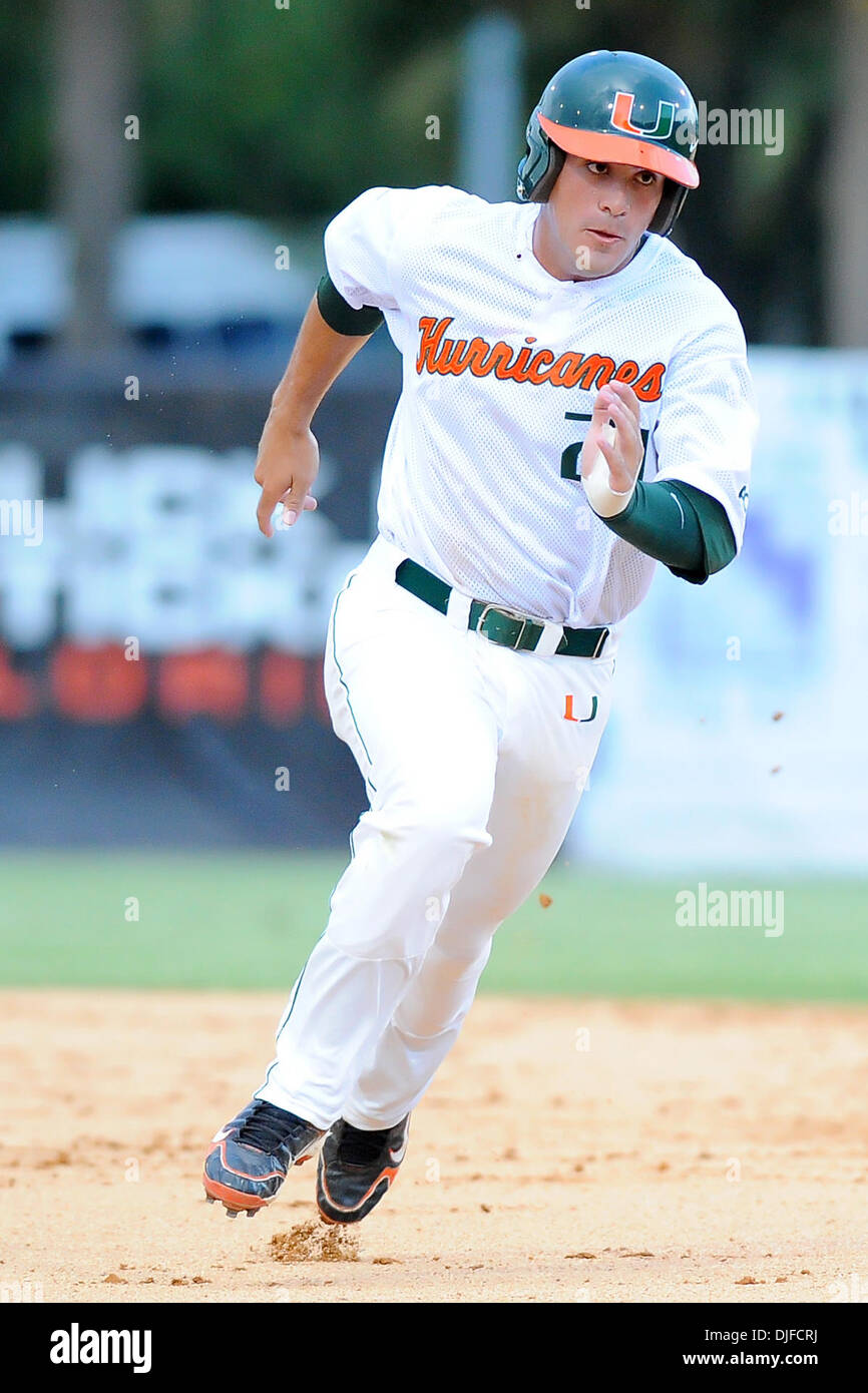 Miami Hurricanes infielder Rony Rodriguez (21) rushes towards third ...