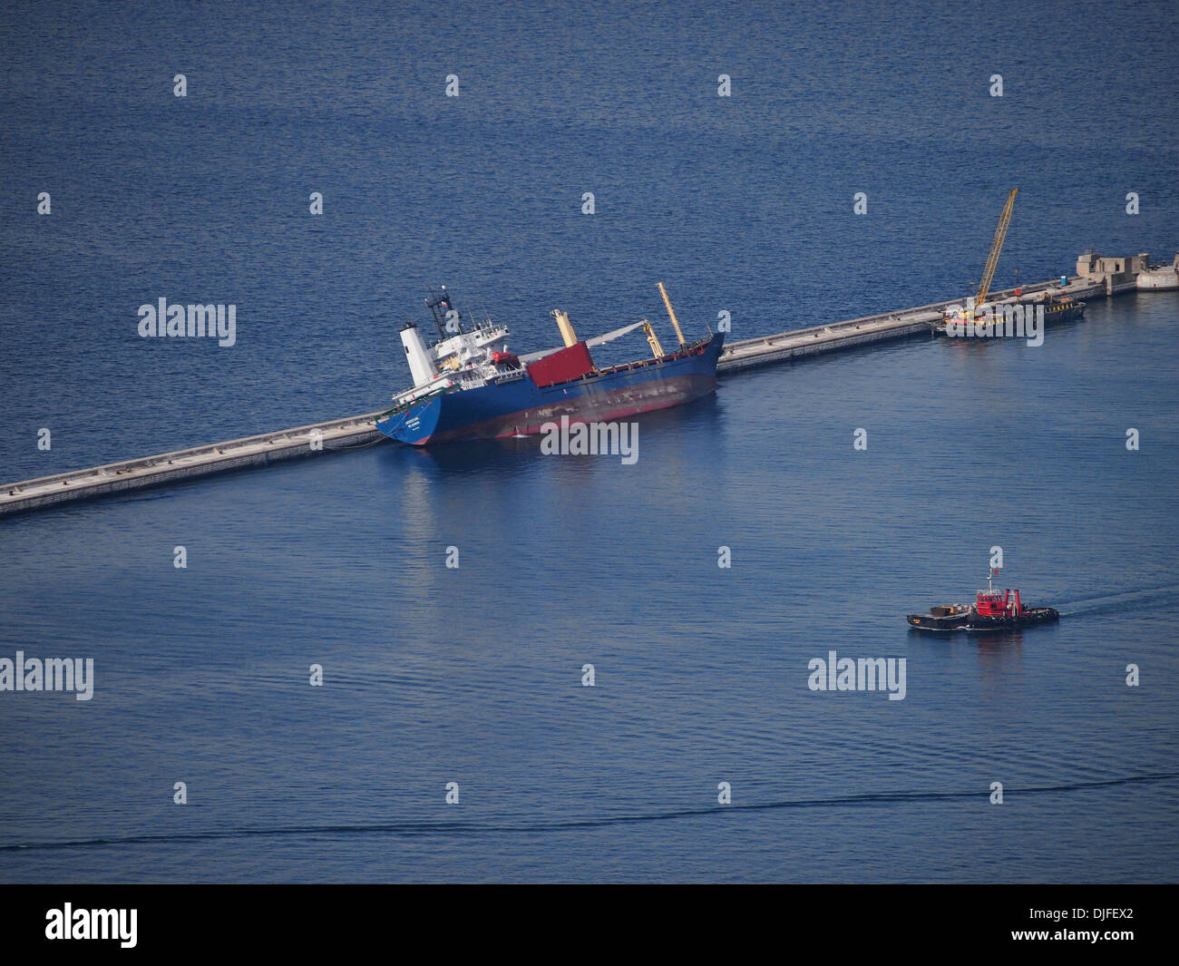 Vessel at Detached Mole in Gibraltar on its side after its load shifted ...