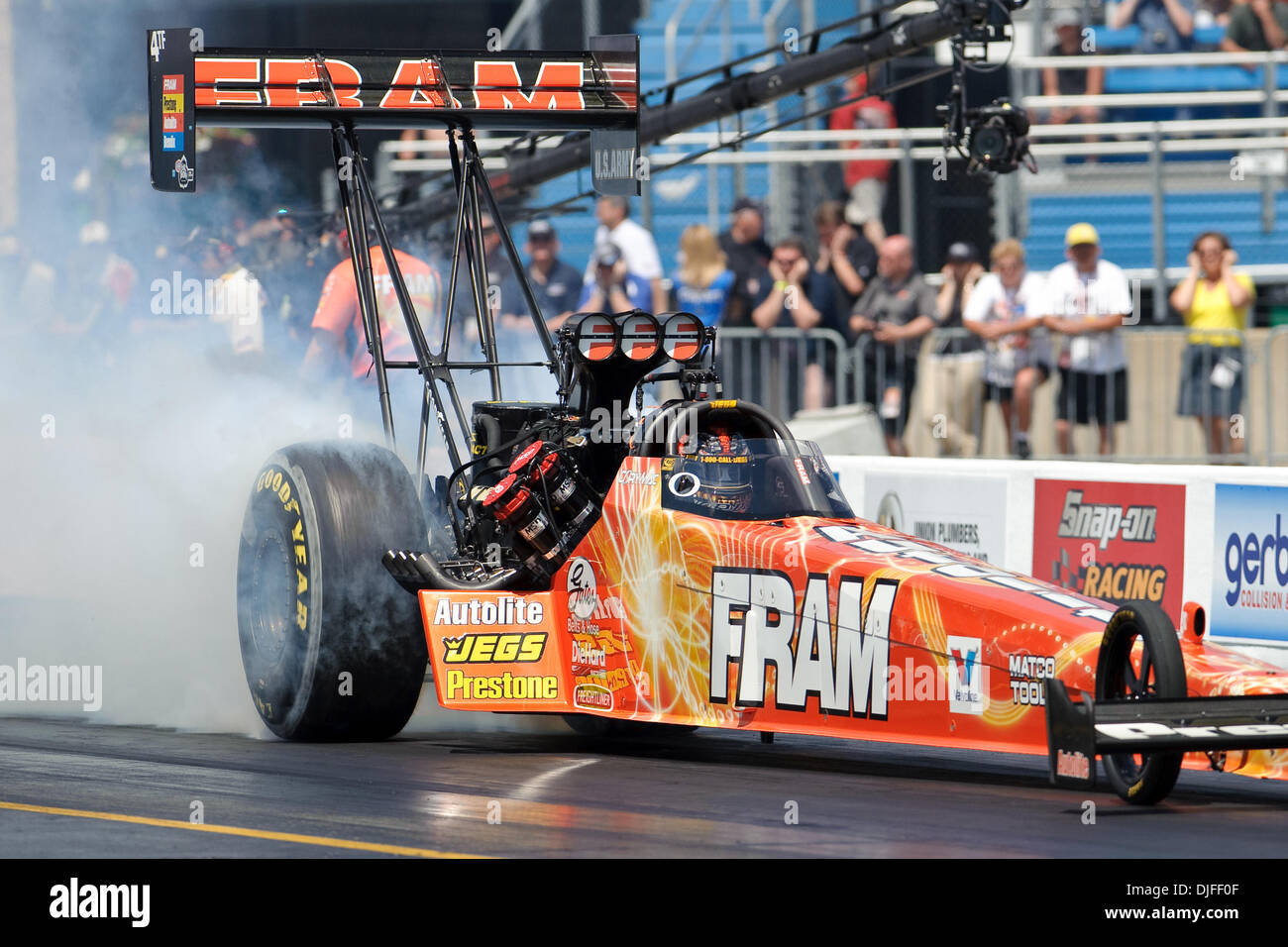 Corry McClenathan does a burnout in his FRAM Top Fuel dragster prior to ...