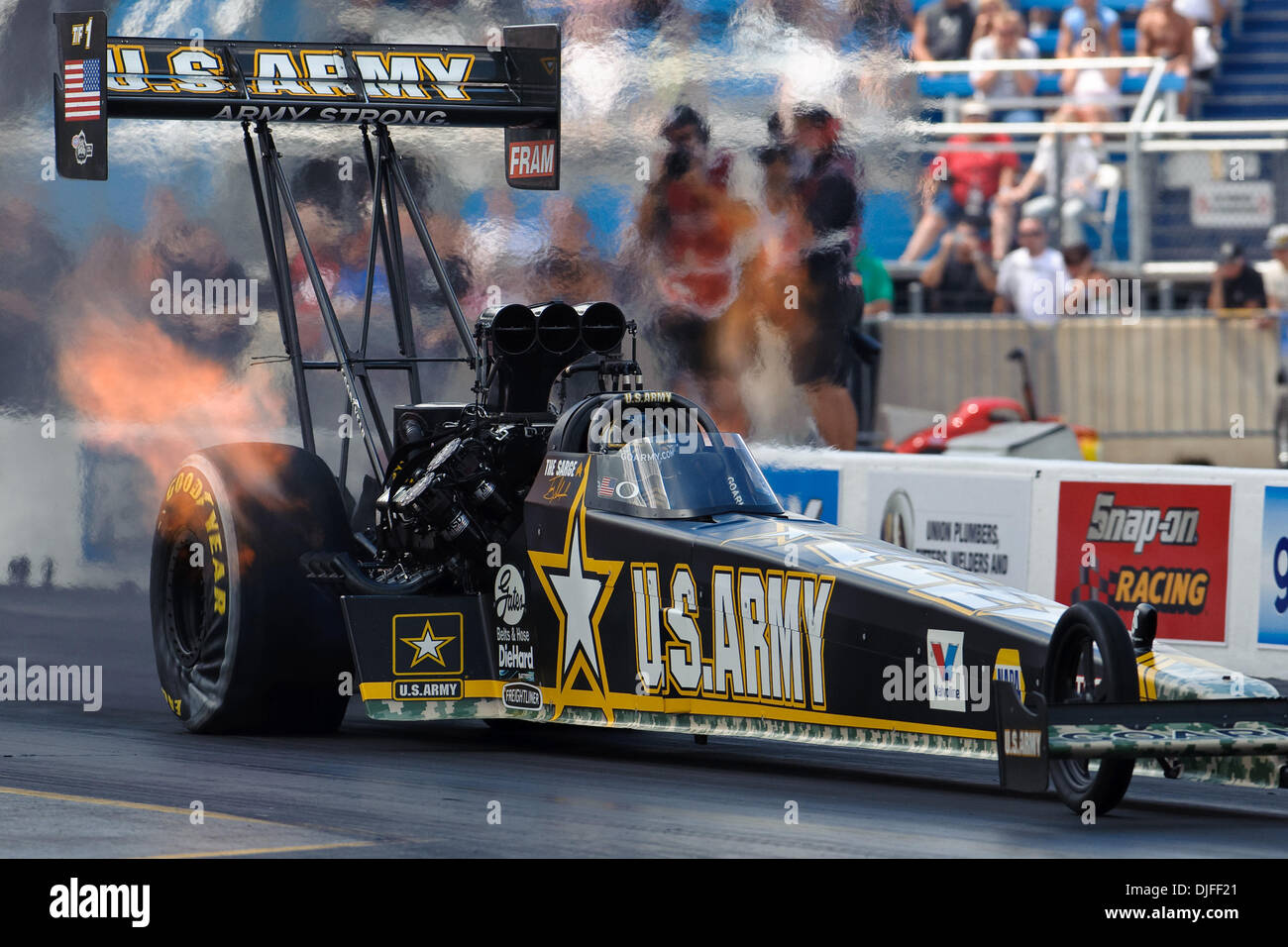 Tony Schumacher races down the track in his US Army Top Fuel dragster ...