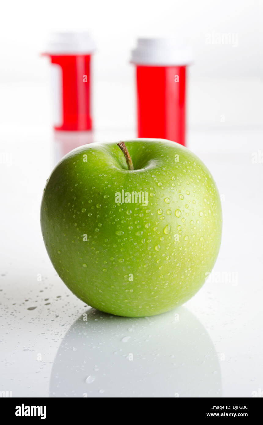 An apple with pill bottles Stock Photo - Alamy