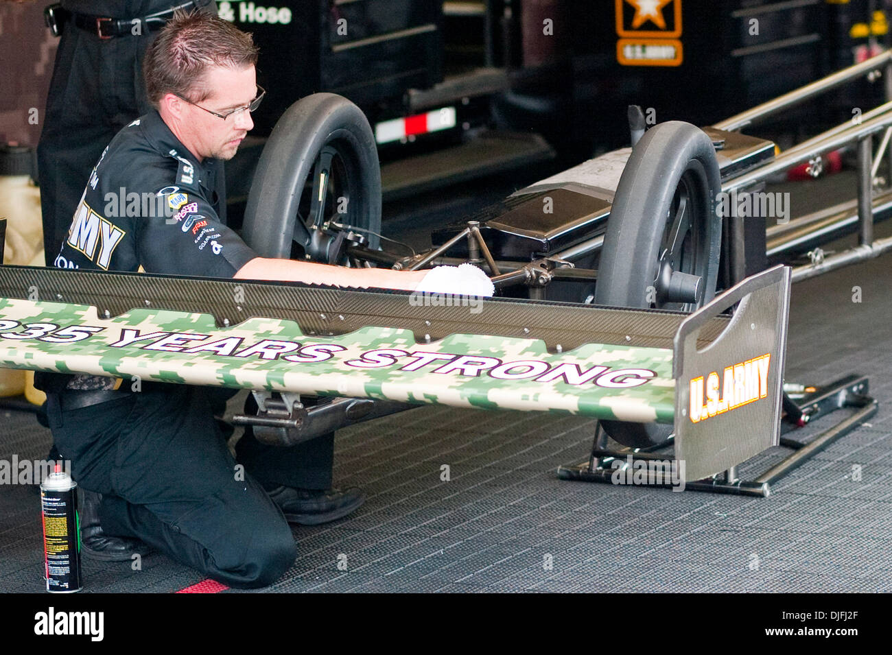 A crew member works on Tony Schumacher's U.S. Army dragster during the ...