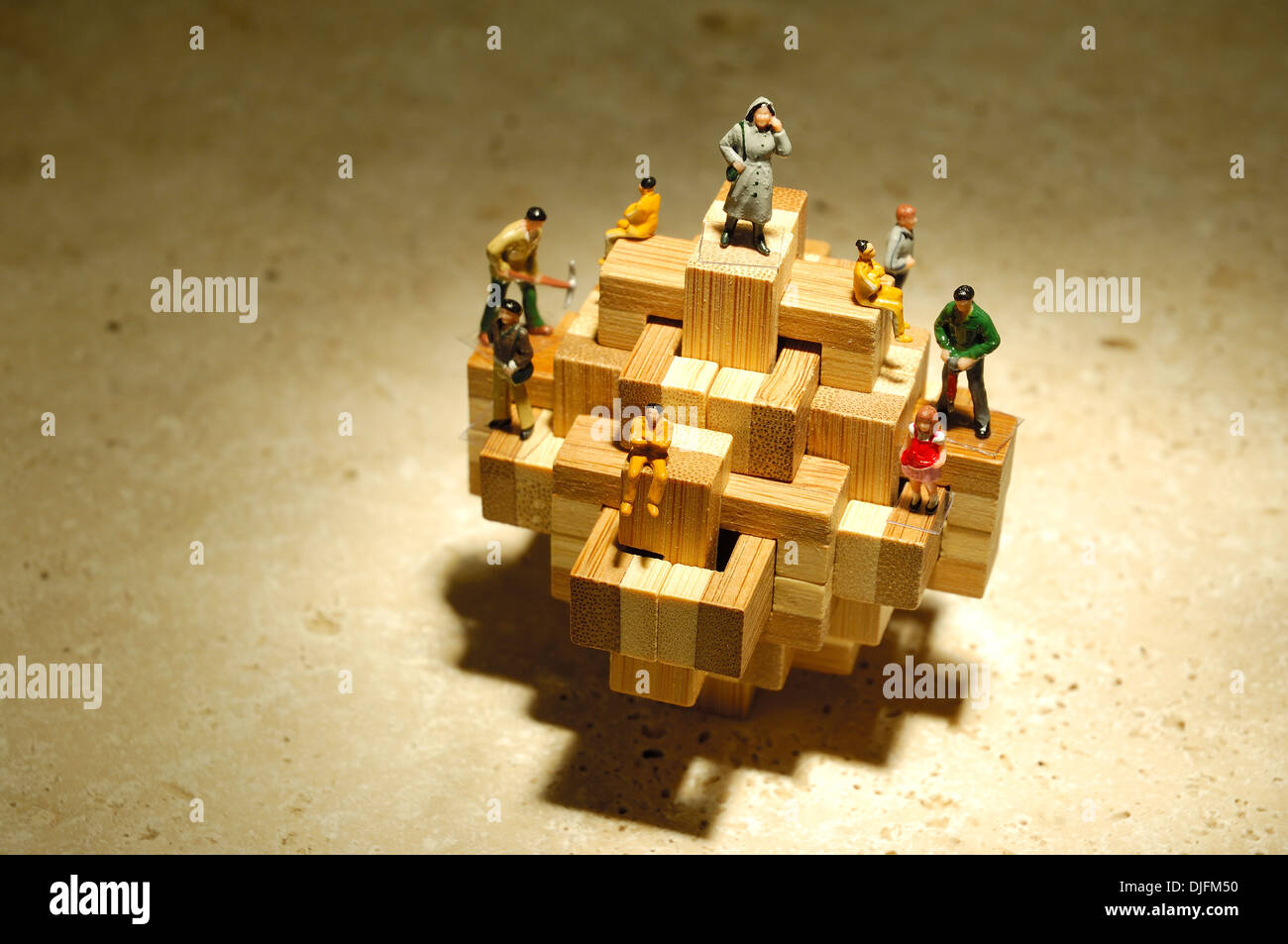 Puzzle with small people figures Stock Photo - Alamy