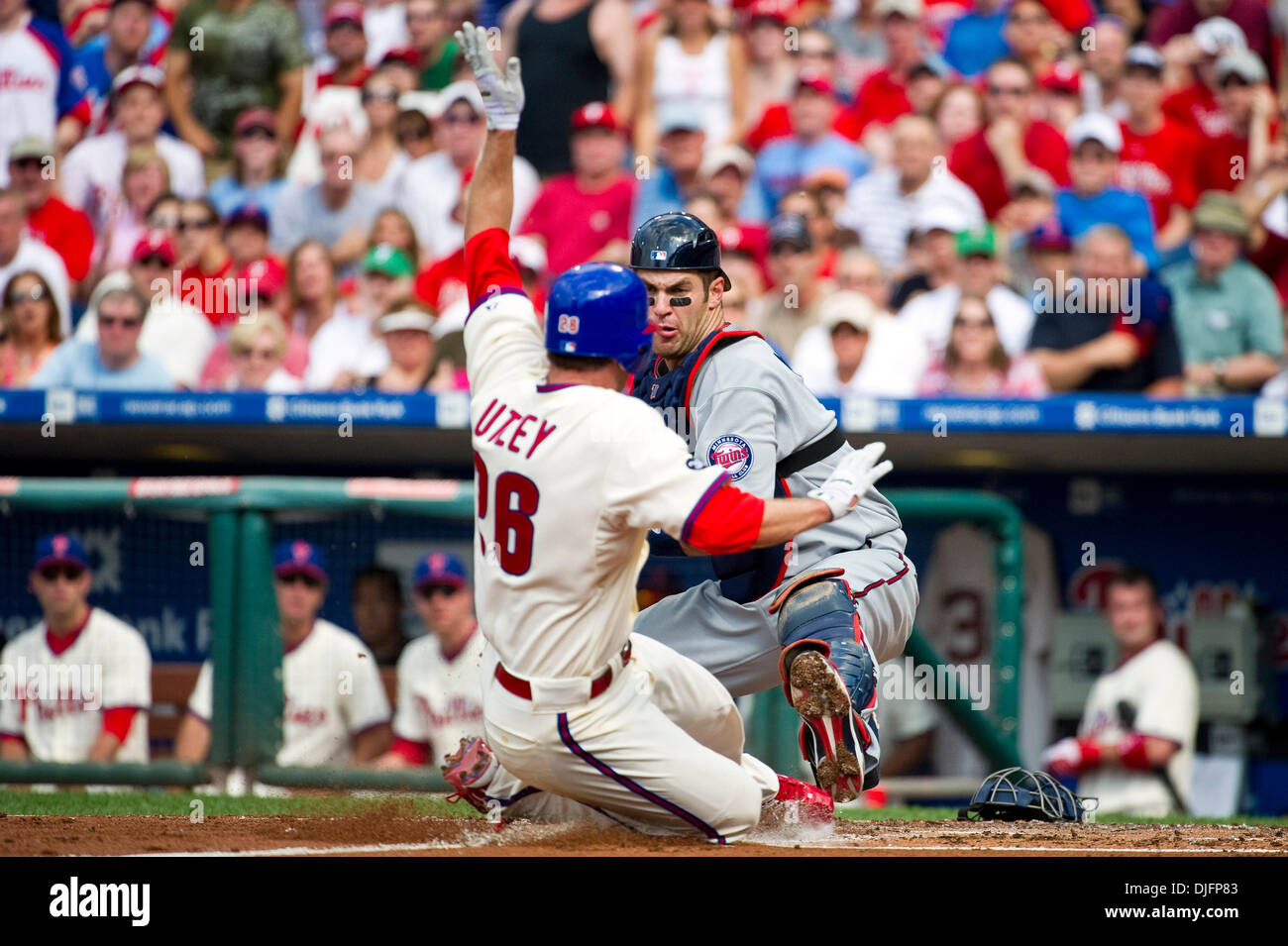Phillies second baseman Chase Utley #28 slides safe into home as Twins ...