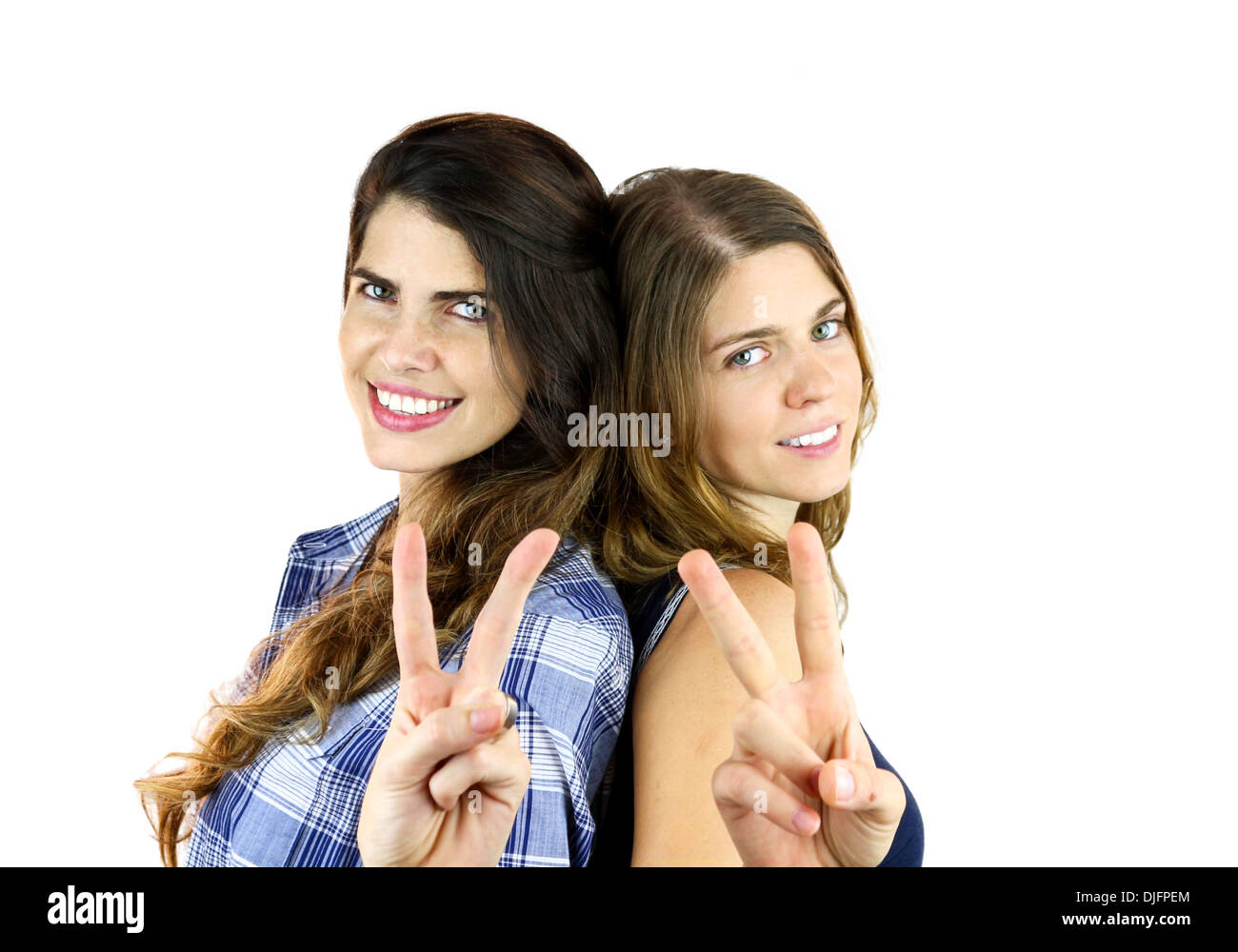 Two happy female friends showing victory sign with hands Stock Photo ...