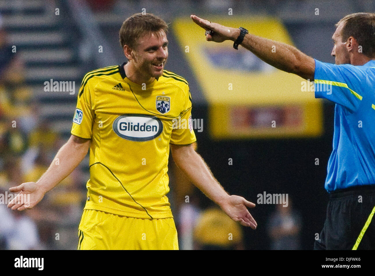 Crew midfielder Eddie Gaven (12) disagrees with referee Terry Vaughn's ...