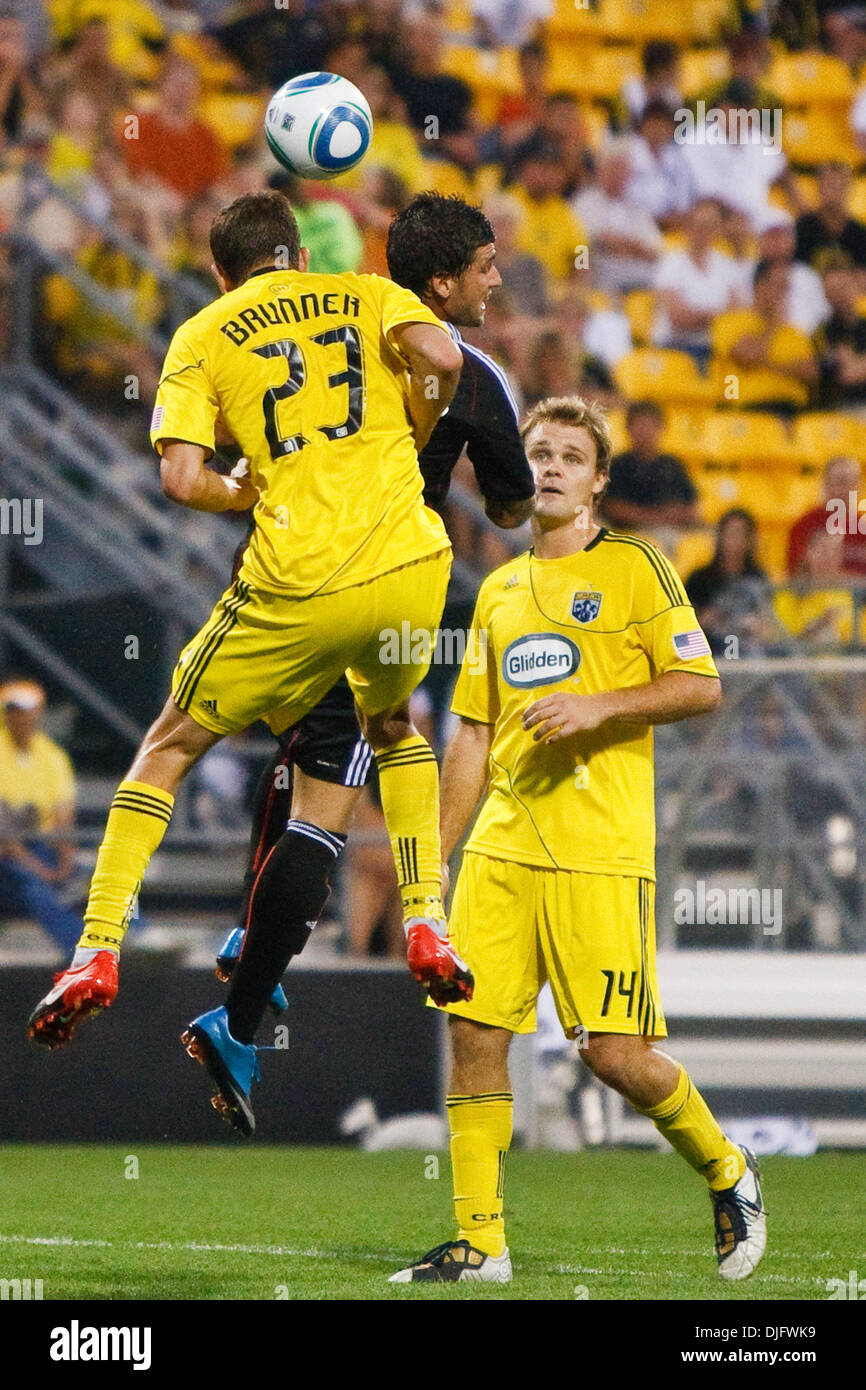 Crew defender Eric Brunner (23) heads the ball as teammate defender ...
