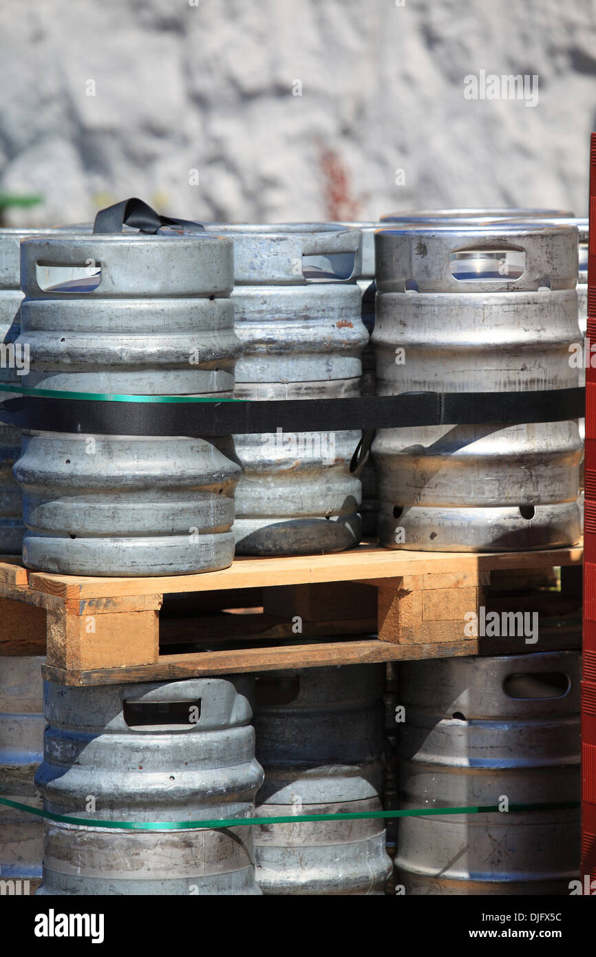 Lots of metal barrels beer kegs on the wooden palettes at factory ...