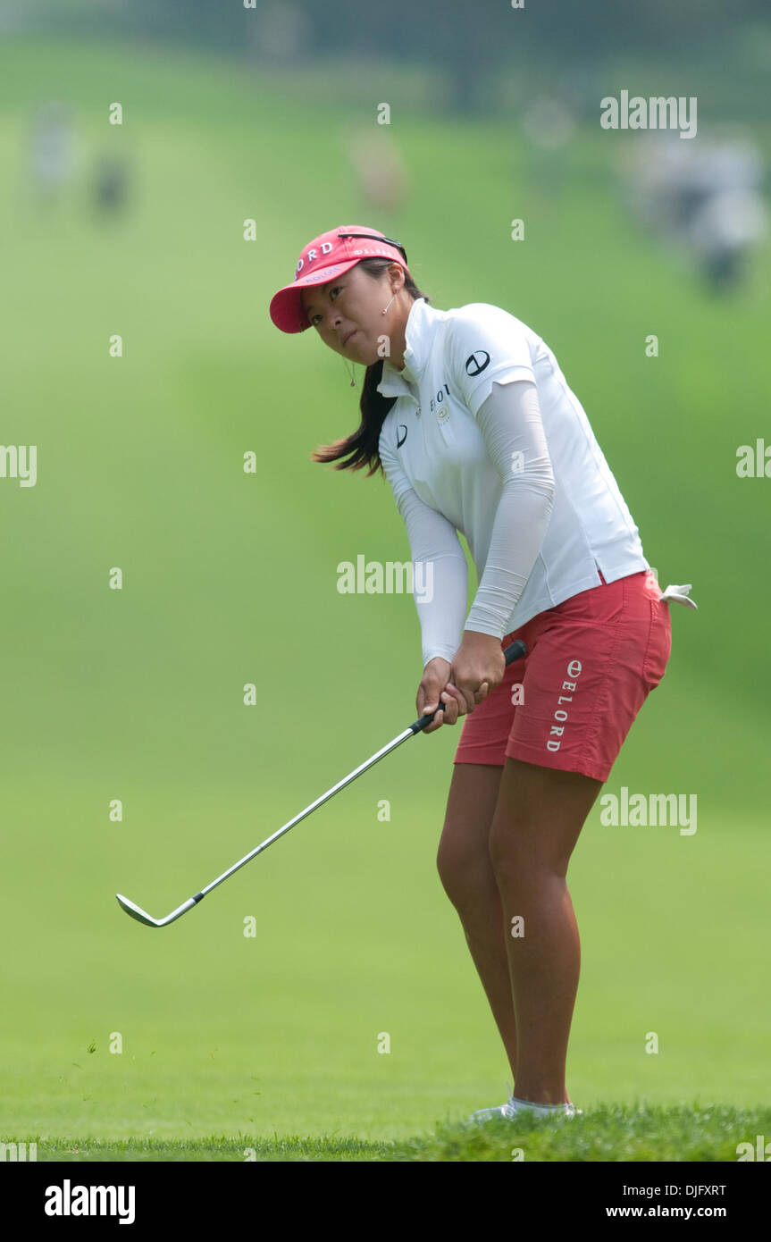 Golfer M.J. Hur hits a pitch shot to the 4th green during the final ...