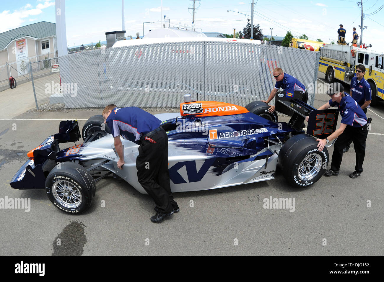The crew for the KV Racing Technology Honda pushes the car from the gas ...