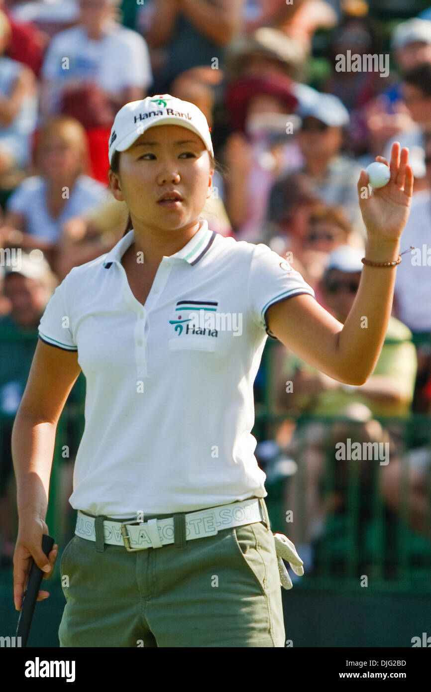 In-Kyung Kim, of South Korea, waves to the fans surrounding the 18th ...
