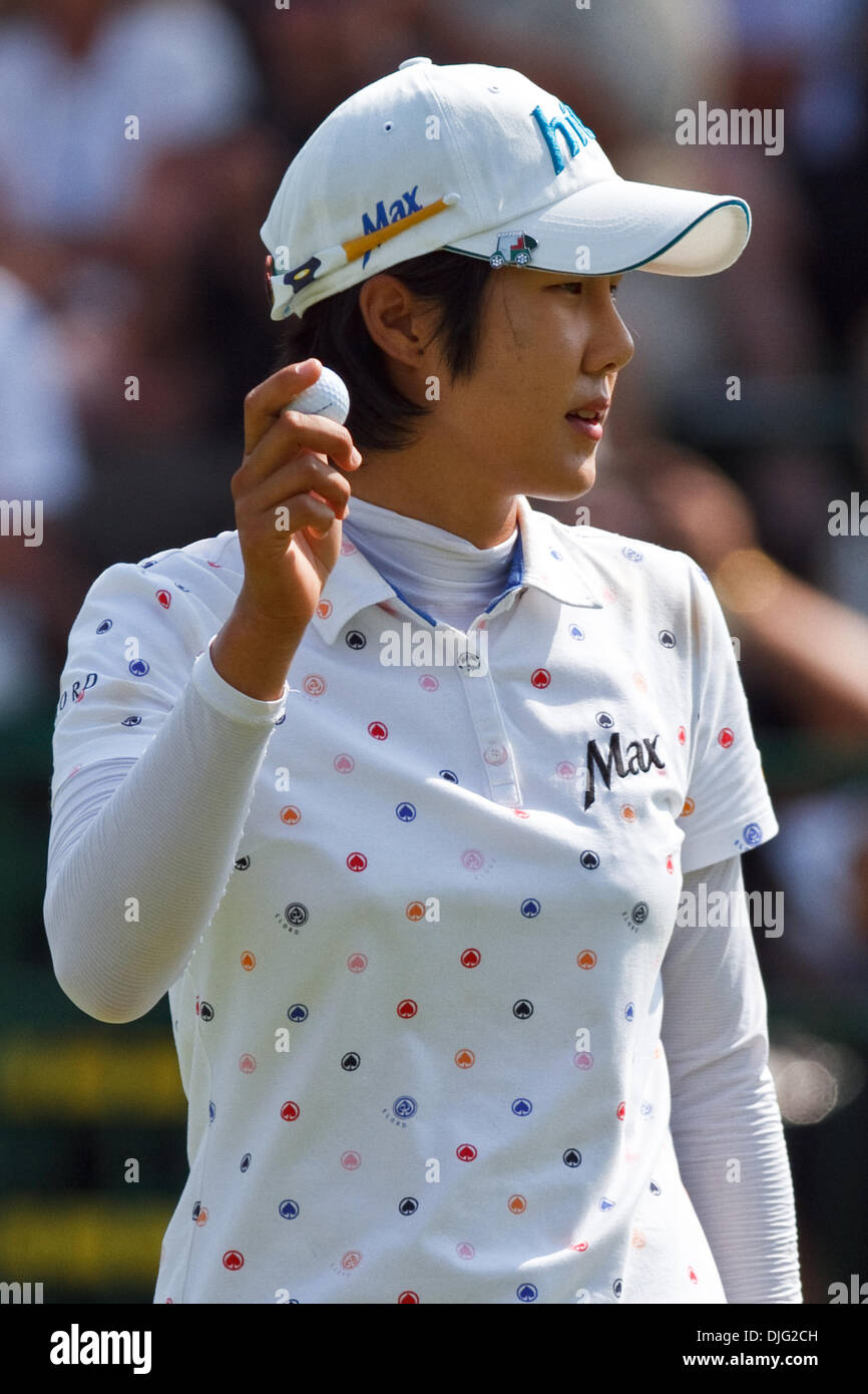 Song-Hee Kim, of South Korea, waves to the fans surrounding the 18th ...