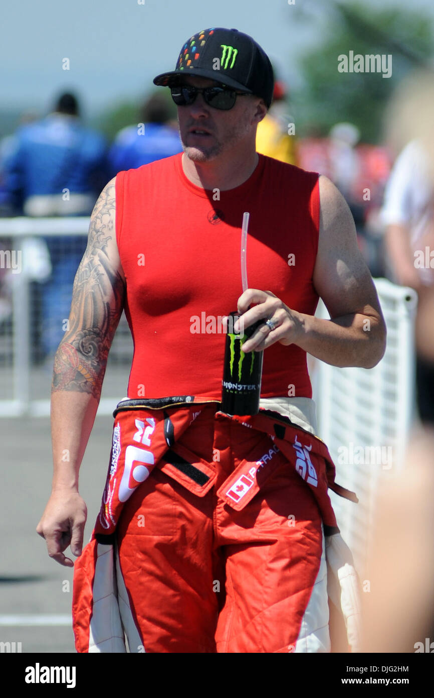 Canadian driver Paul Tracy walks pit lane to get ready for driver ...
