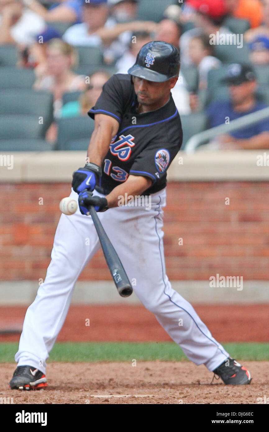 New York Mets infielder Alex Cora (#13) hits low on the bat during the ...