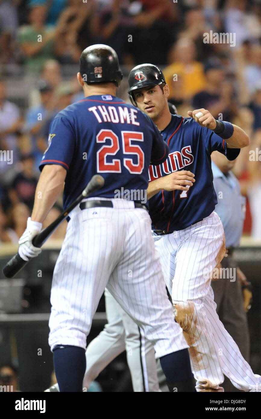 Minnesota Twins catcher Joe Mauer #7 is greeted by Jim Thome #25 as he ...