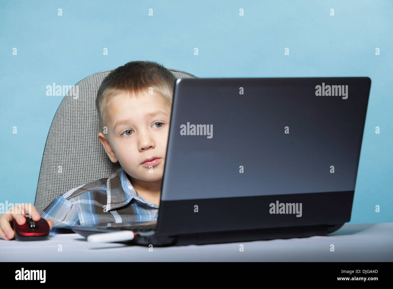 Computer addiction child boy with laptop notebook blue background Stock ...