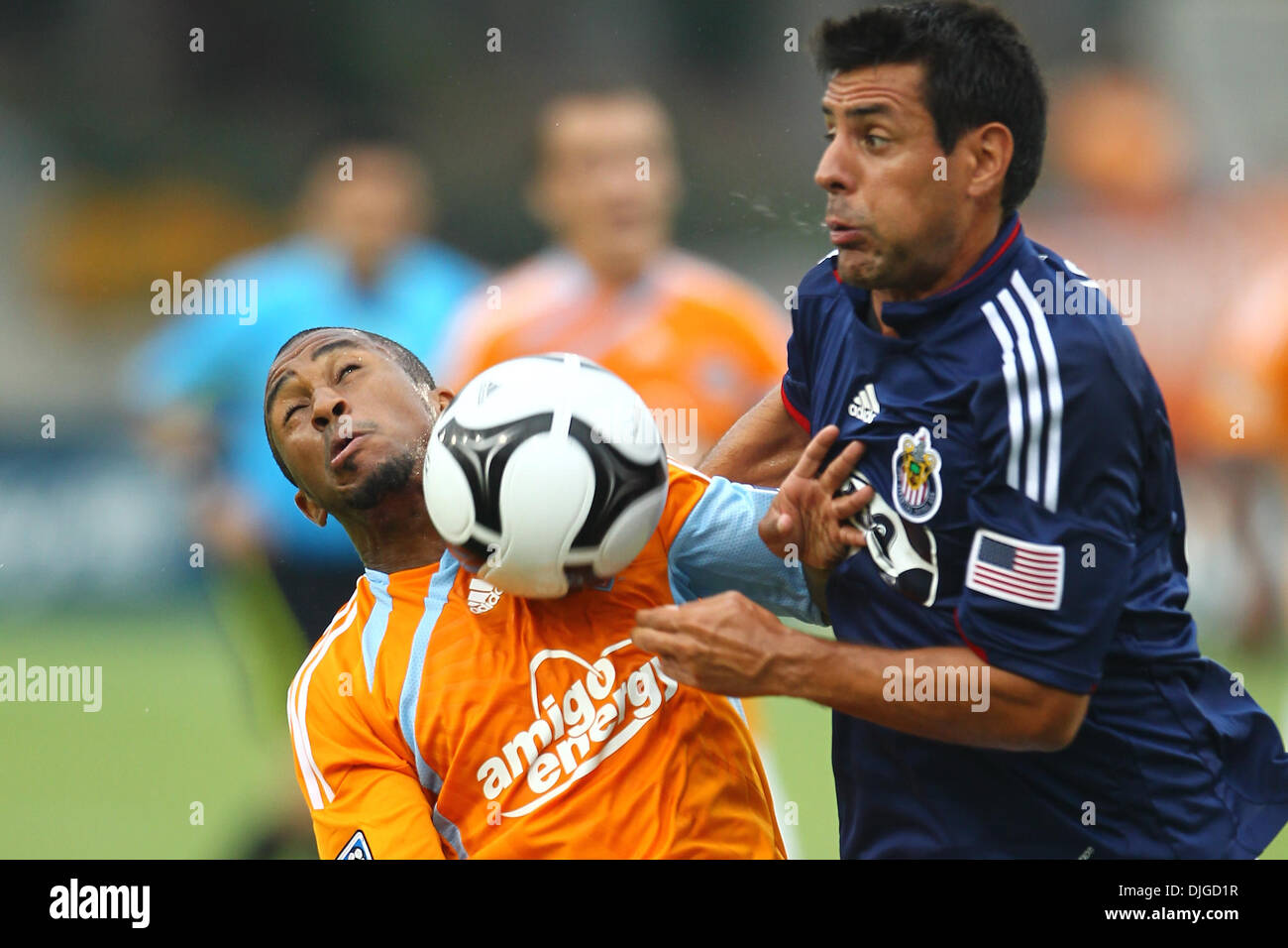 Corey Ashe (#26) Midfielder for the Houston Dynamo collides with Ante ...