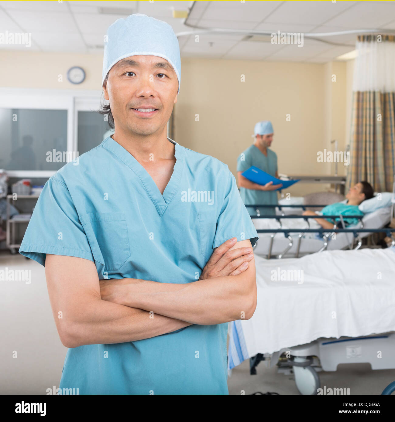 Male Nurse Standing In Hospital Ward Stock Photo - Alamy