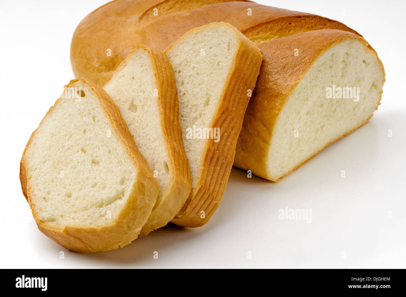 Detail of a piece of traditional white bread with three cut slices ...