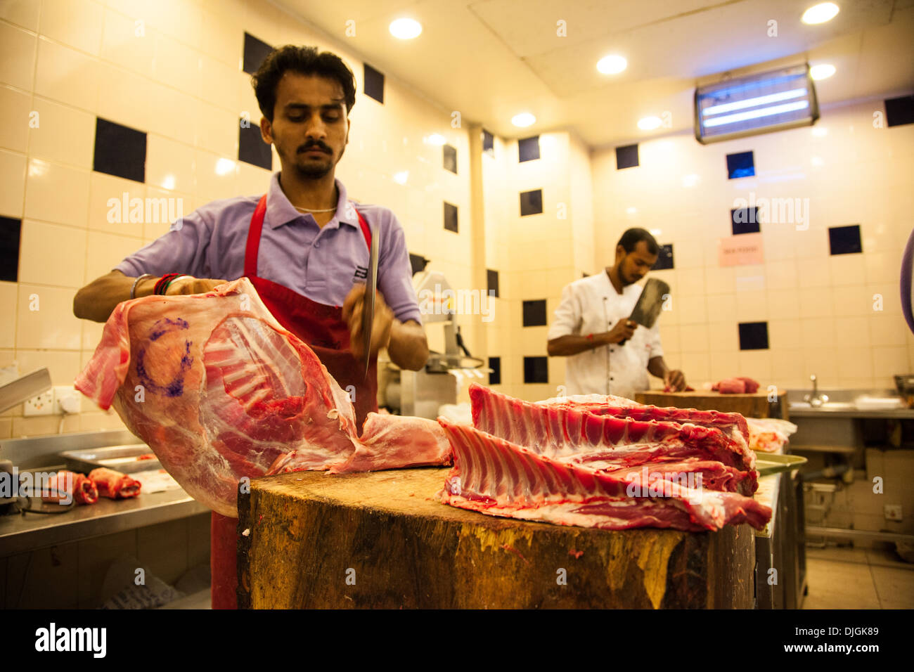 Butcher chopping raw meat on a cutting board Stock Photo - Alamy