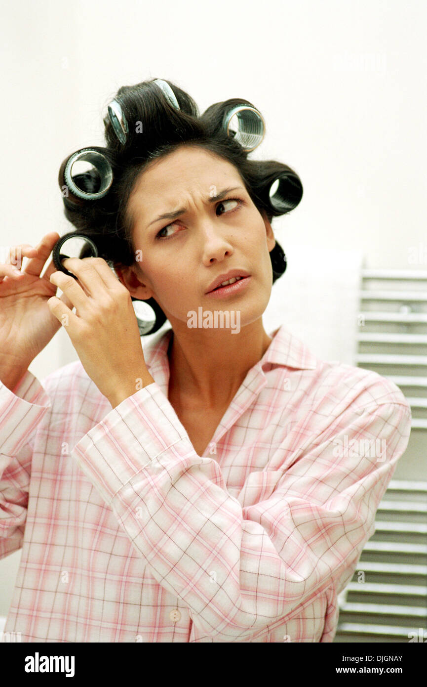 Woman in pajamas hair in rollers Stock Photo - Alamy